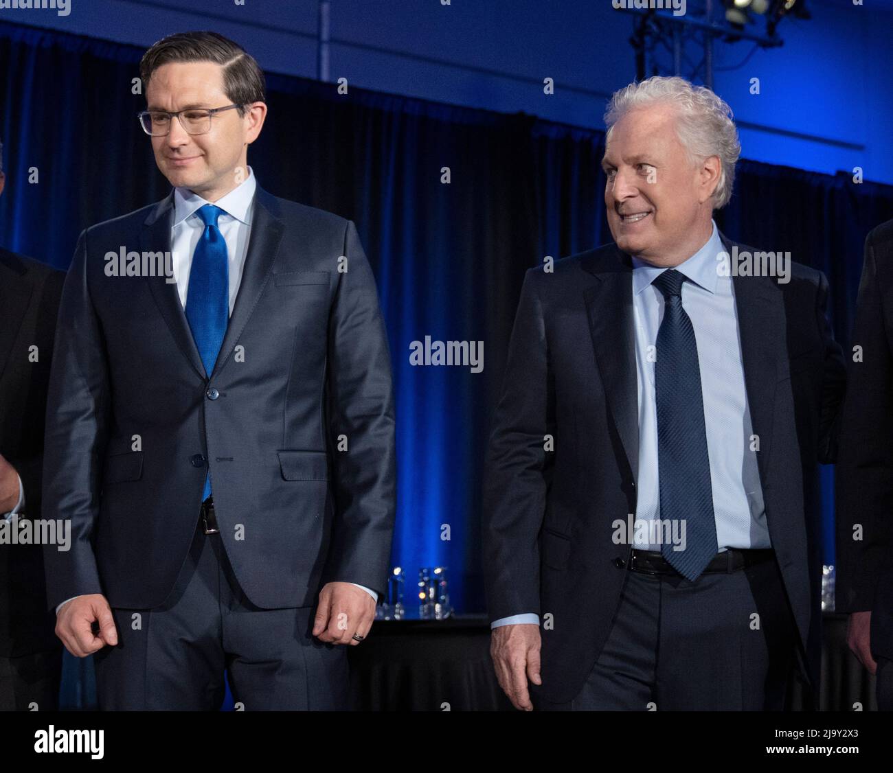 Candidates Pierre Poilievre, left, and Jean Charest leave the stage ...