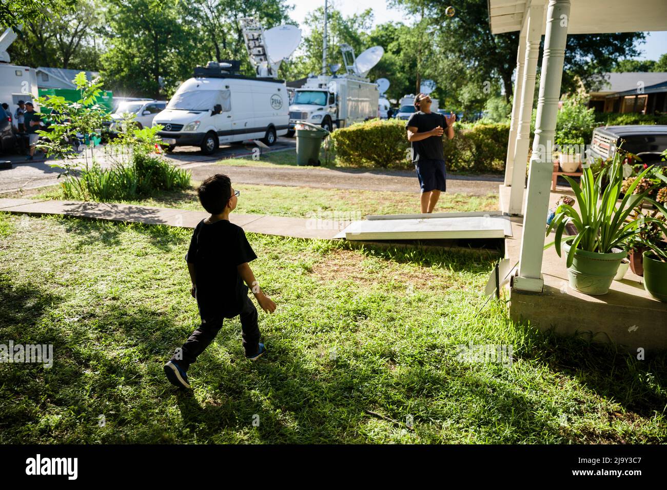 May 25, 2022: Isaac Morales, 7, plays catch with his brother, Benjamin ...