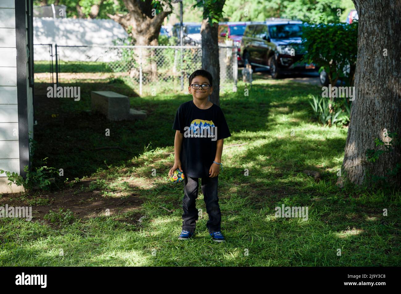 May 25, 2022: Isaac Morales, 7, plays catch with his brother, Benjamin ...