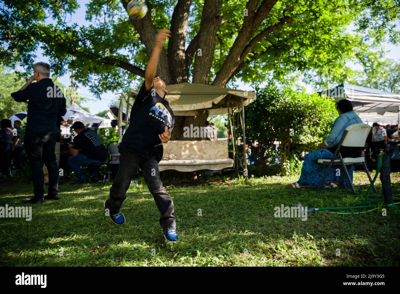 May 25, 2022: Isaac Morales, 7, plays catch with his brother, Benjamin ...