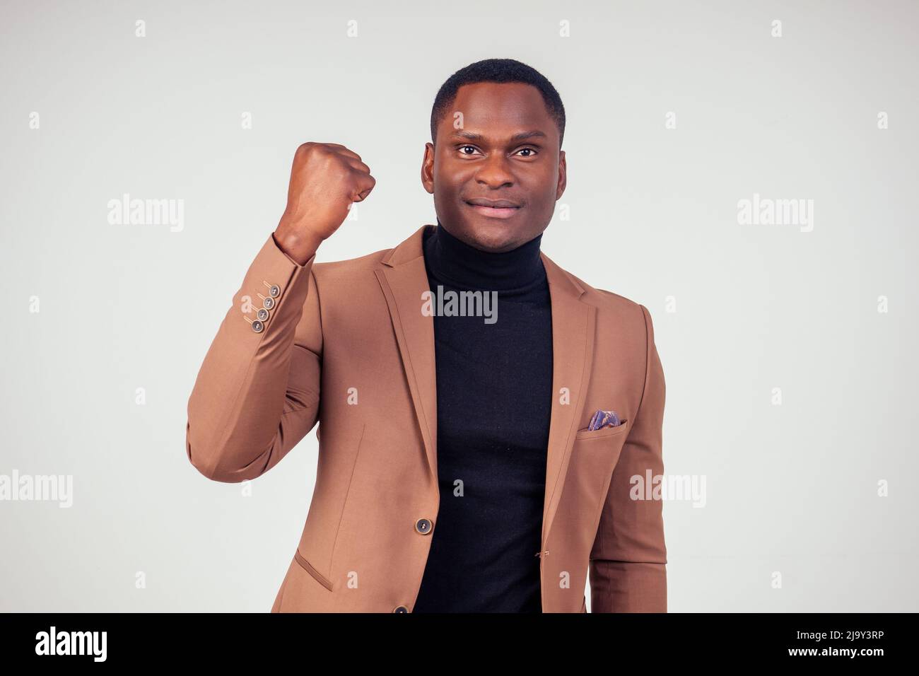 handsome young Afro American businessman in classic suit rejoicing and ...