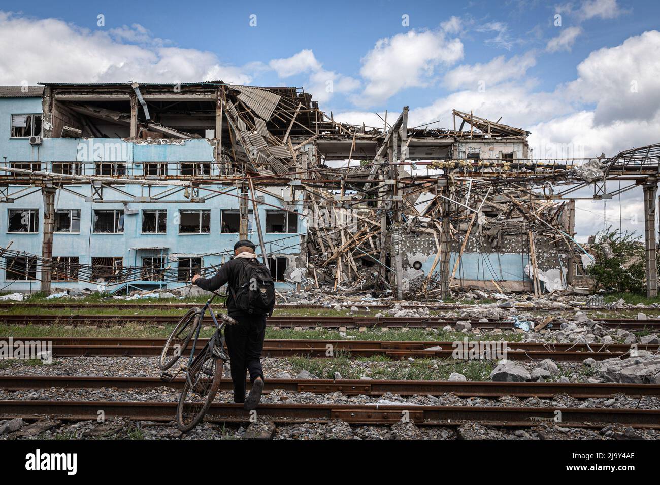 Soledar, Ukraine. 22nd May, 2022. A man with a bicycle can be seen ...