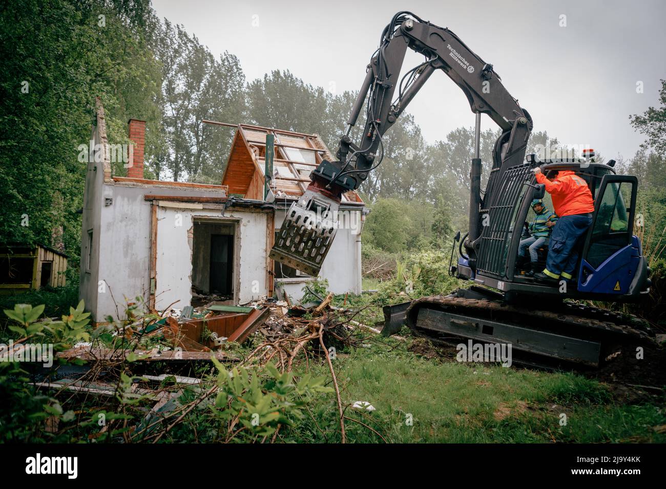 a ruined house is demolished with an excavator from the THW technical ...
