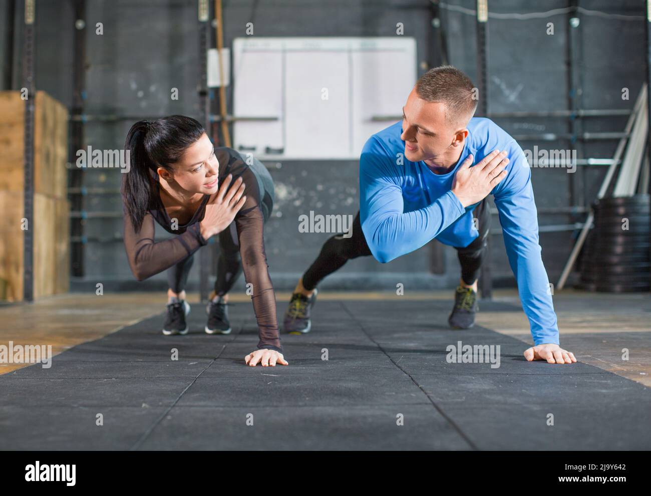 Fitness couple strengthen hands at fitness training. Man and woman ...