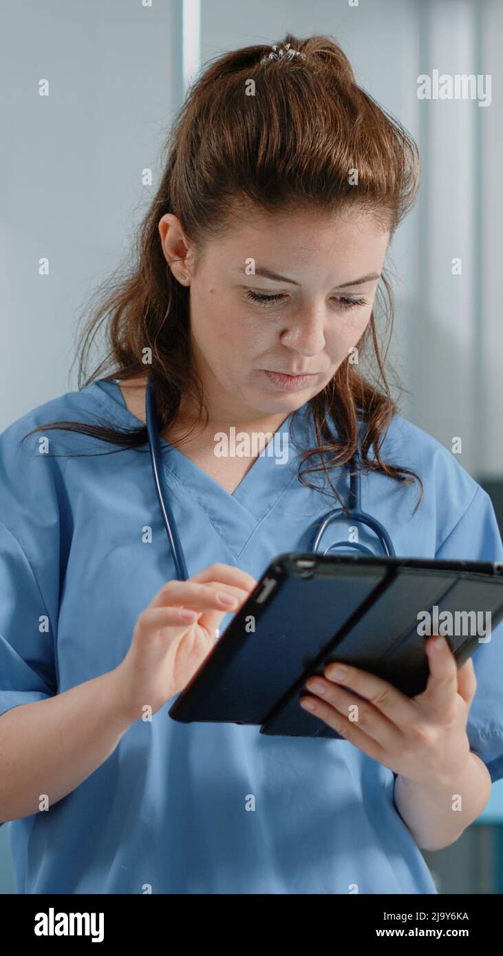 Caucasian nurse using digital tablet with touch screen for treatment ...