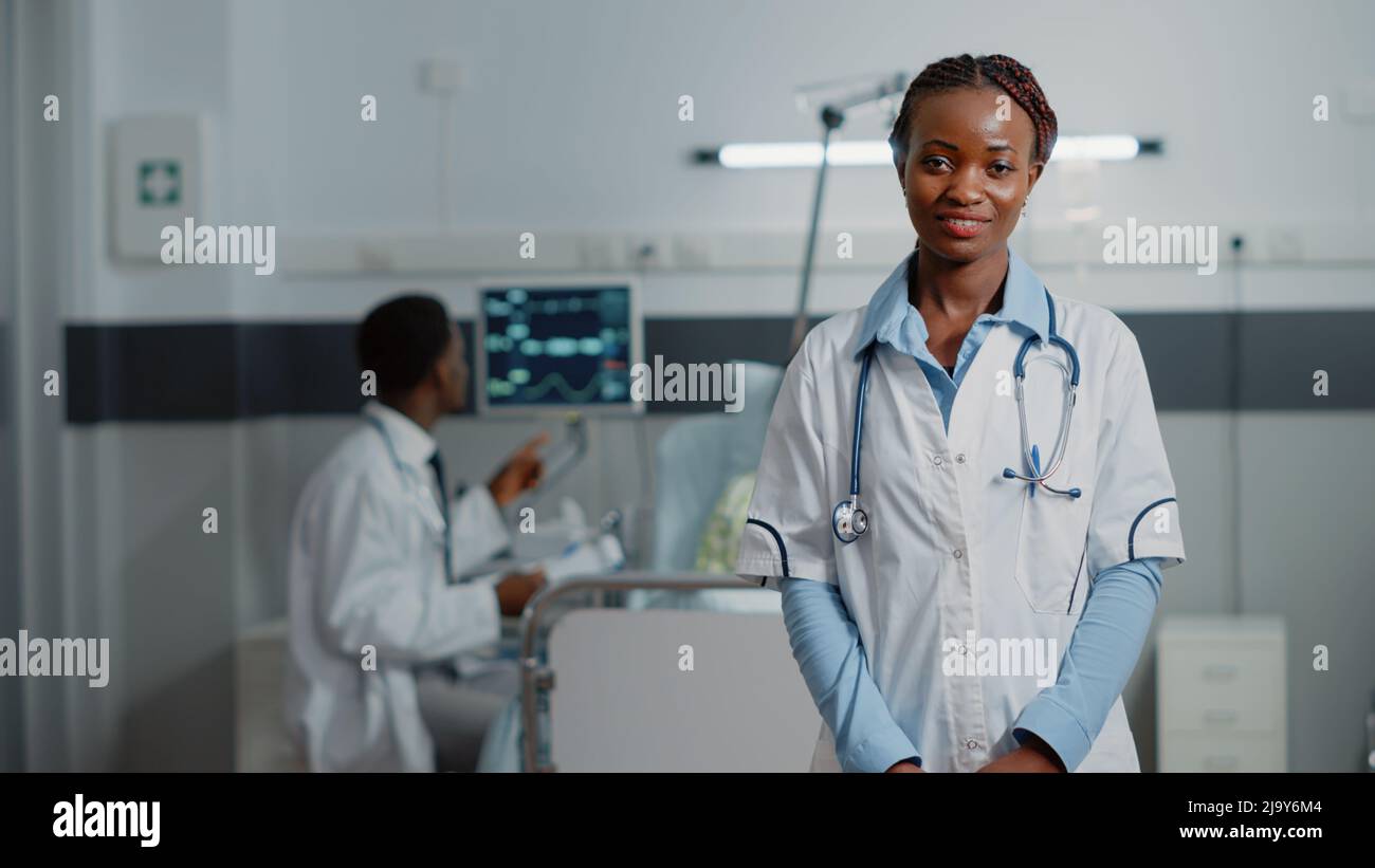Portrait of medical specialist with white coat and stethoscope standing ...