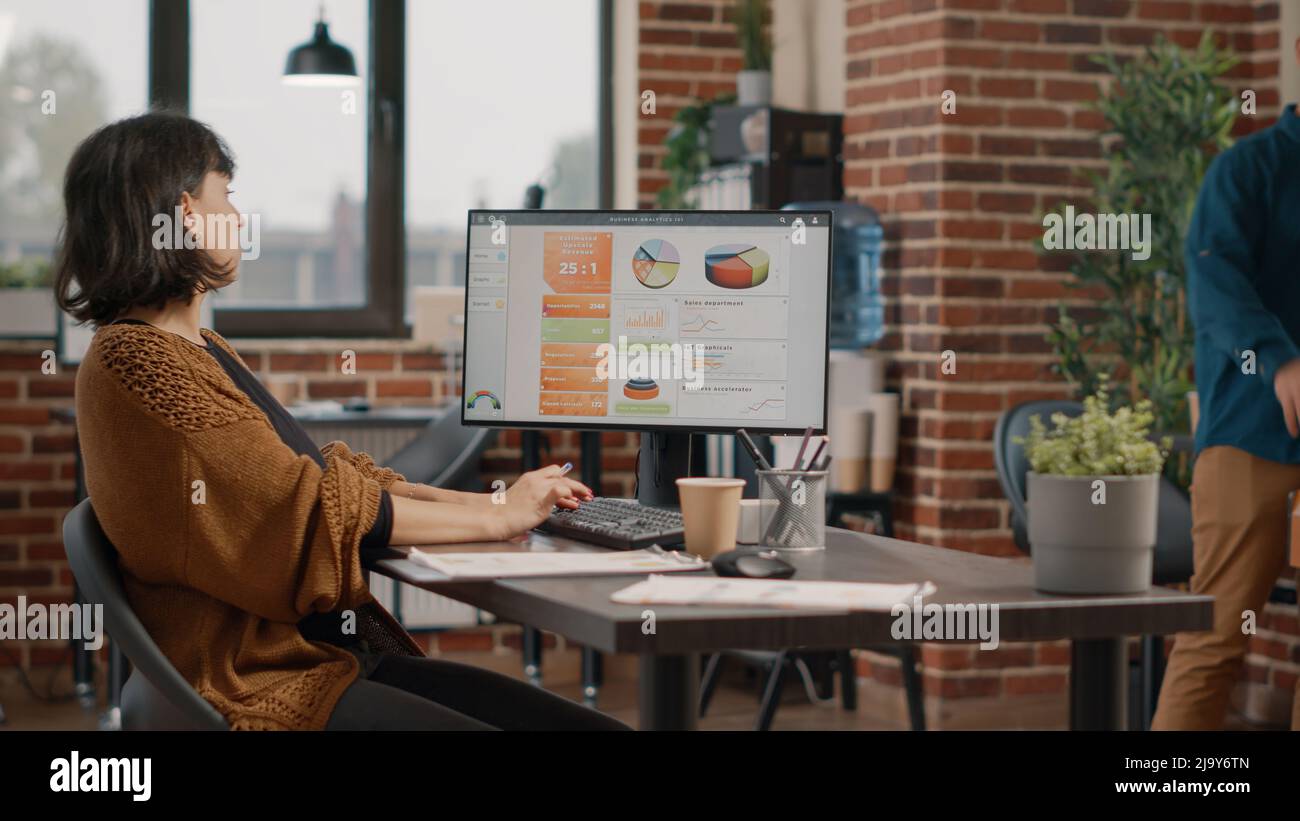 Stressed employee using computer and keyboard to plan project and ...