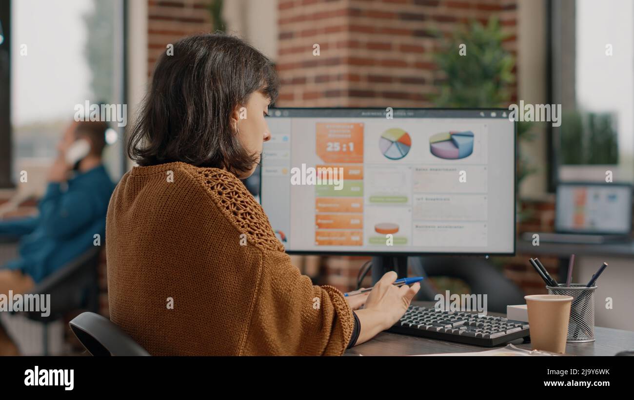 Business woman working on project planning with rate charts and ...