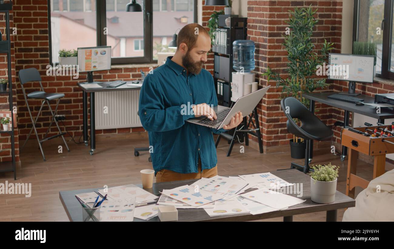 Business man feeling happy about successful project win, reading news ...