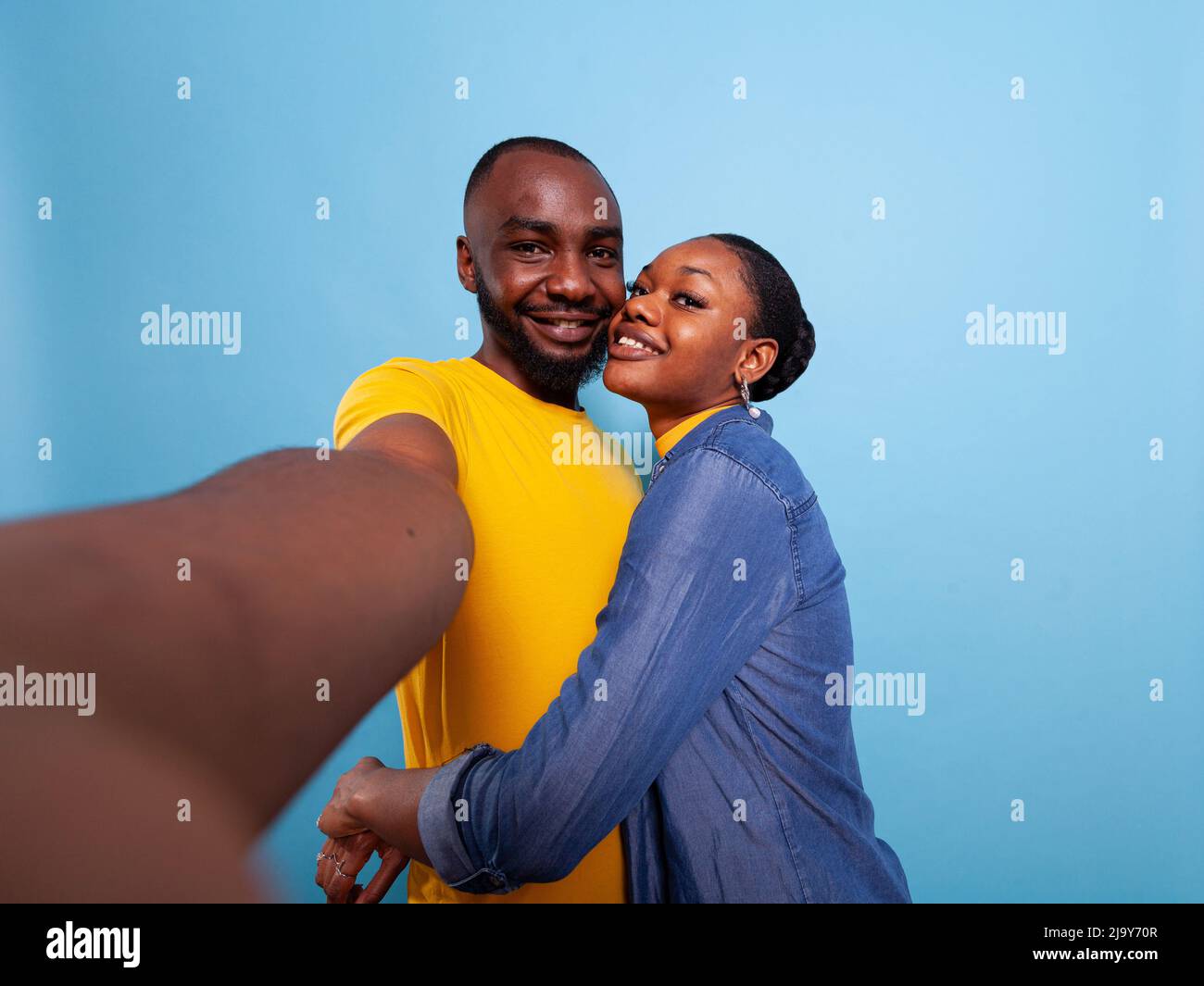 POV of man holding camera and woman hugging him in studio, taking ...