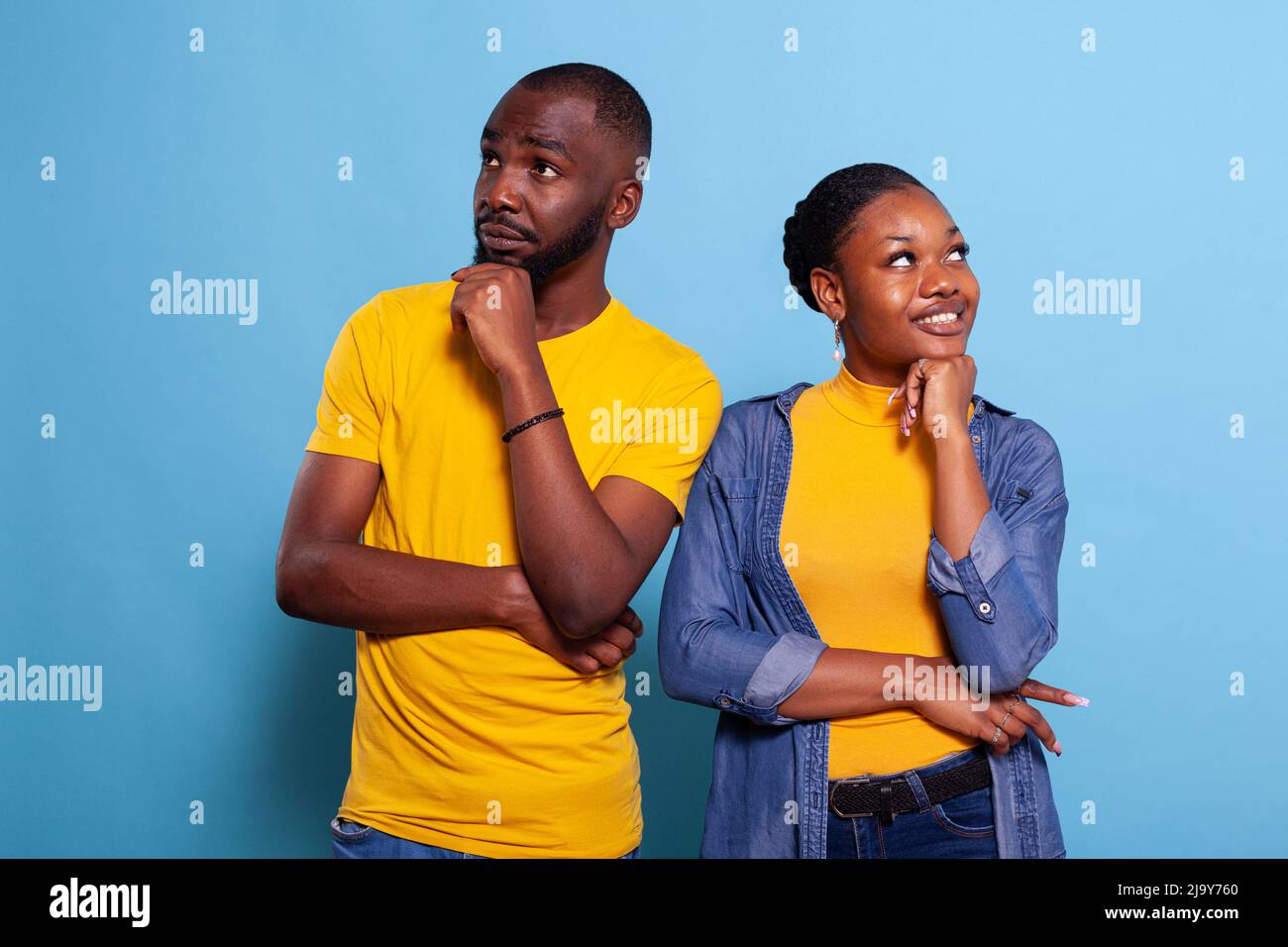 Thoughtful partners brainstorming ideas and looking sideways, feeling ...