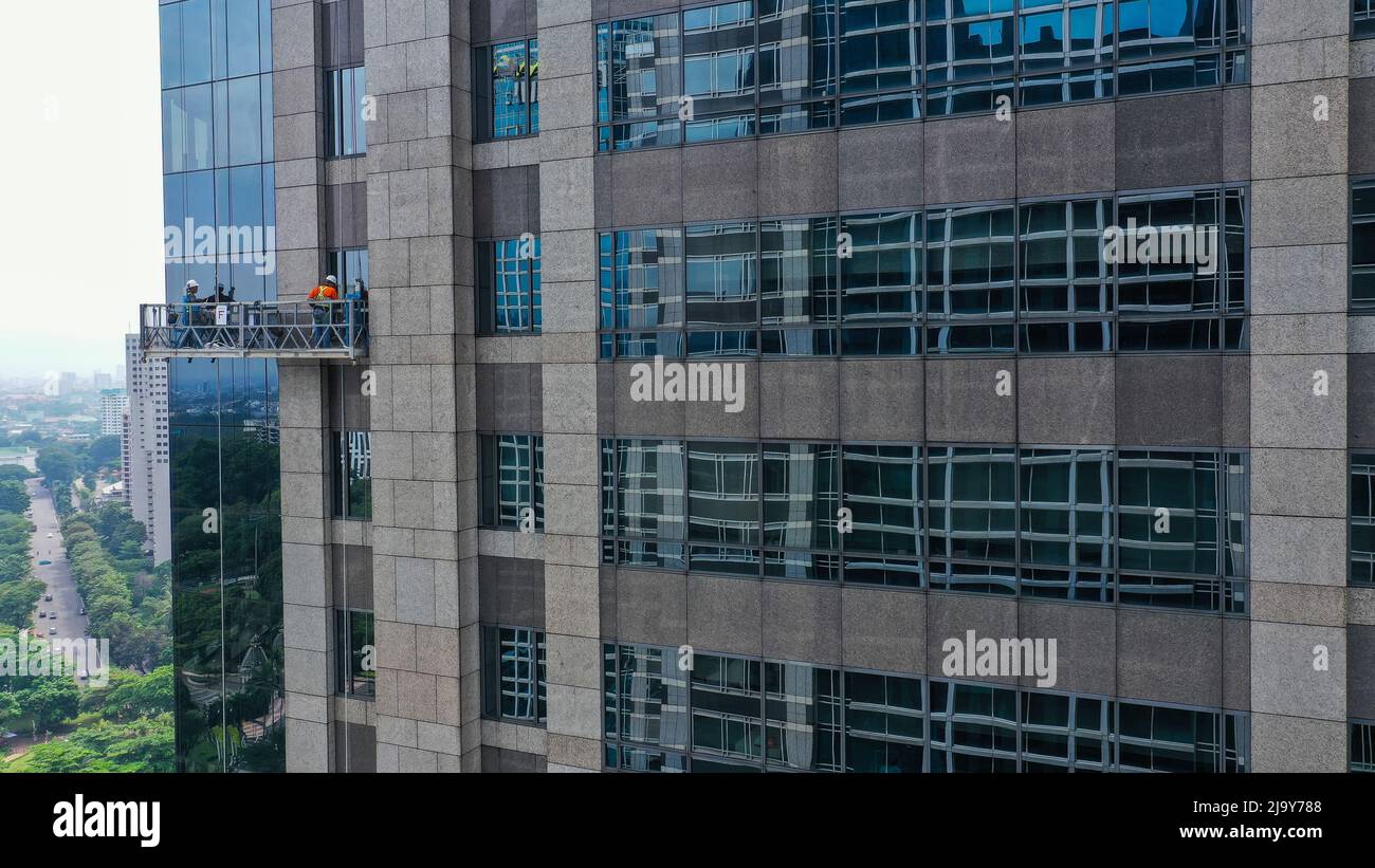 Professional high rise window cleaning service workers in gondola. Two ...