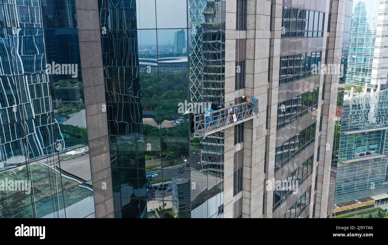 Professional high rise window cleaning service workers in gondola. Two ...