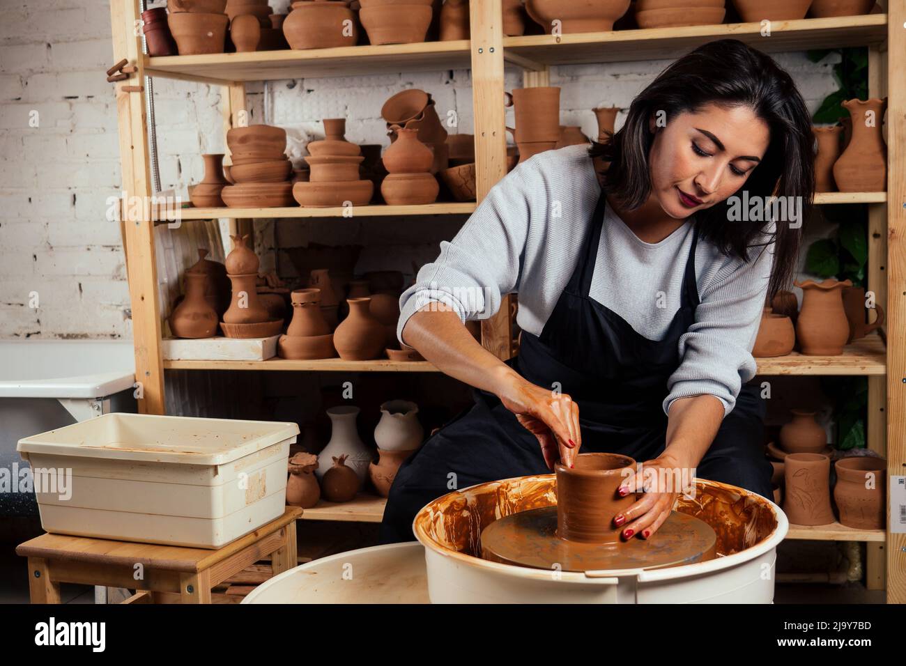 beautiful potter master woman molds from clay pot in mastre. female ...