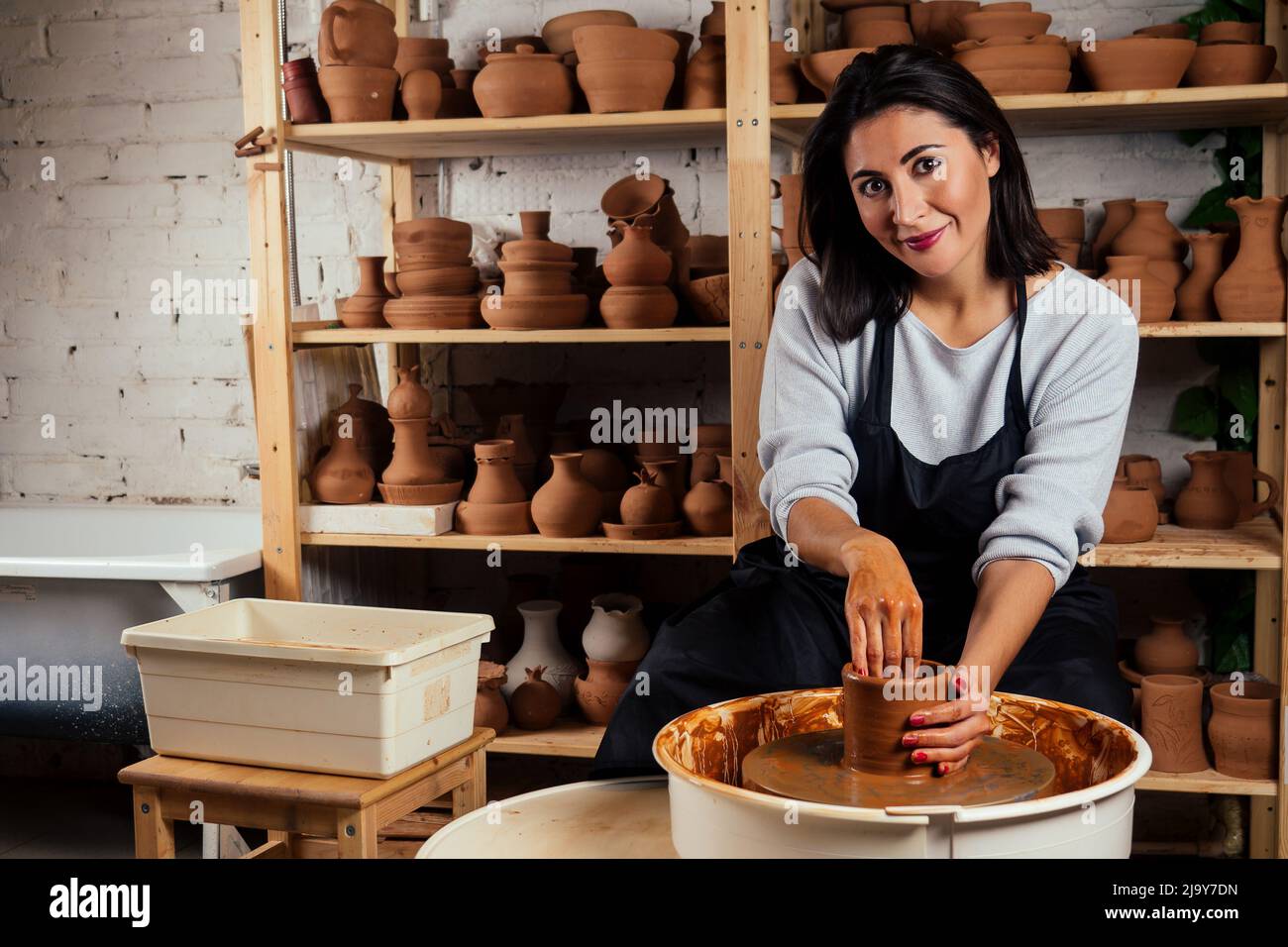beautiful potter master woman molds from clay pot in mastre. female ...