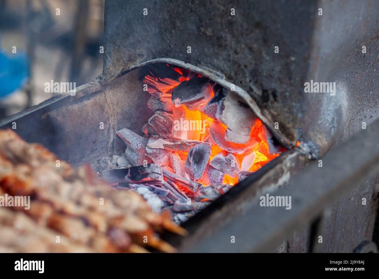 Burning coals in a metal grill for frying meat and vegetables. Cooking ...
