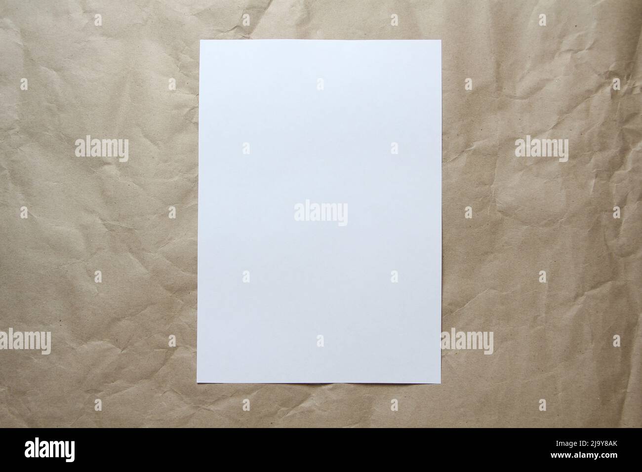 White empty sheet of A4 format on a beige craft paper. Concept of ...