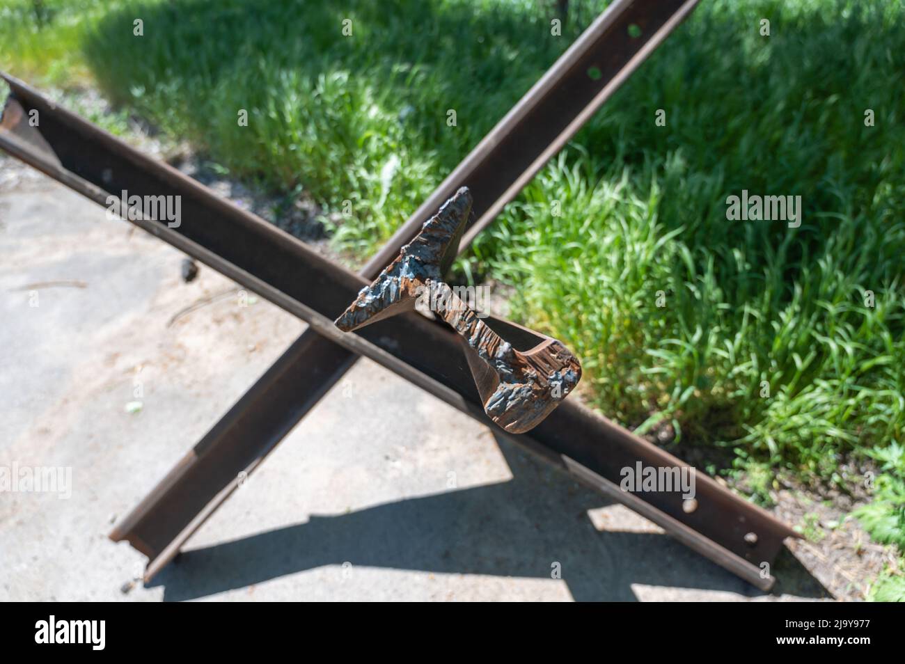 Anti-tank obstacles in the street of a Ukrainian city. Metal barrier ...