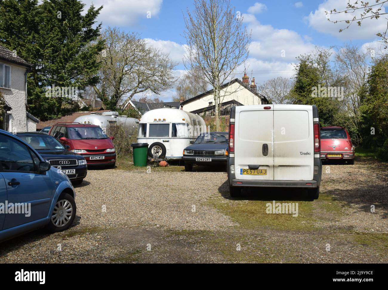 collection of vehicles in front garden Stock Photo - Alamy