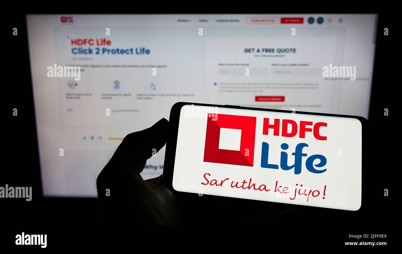 Person holding smartphone with logo of Indian company HDFC Life ...