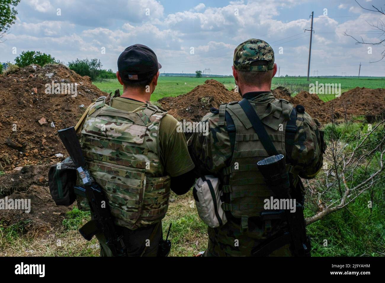 Soledar, Ukraine. 24th May, 2022. Two soldiers looking at the southern ...