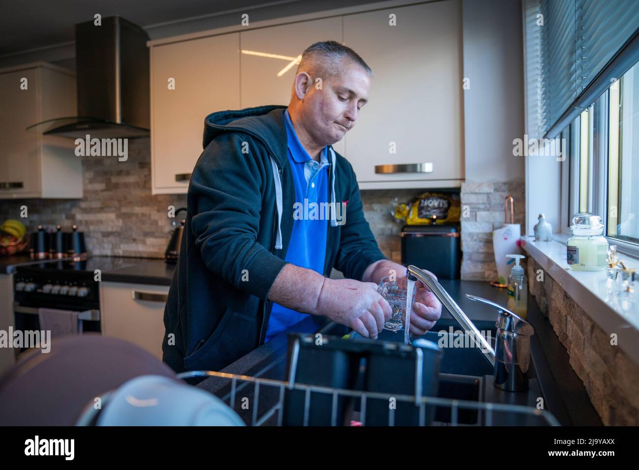 Steven Gallagher, from Dreghorn, Ayrshire, pours himself a glass of ...