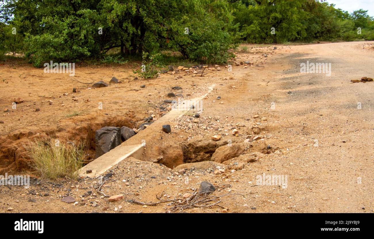 Soil erosion due to flooding on a dirt road Stock Photo - Alamy