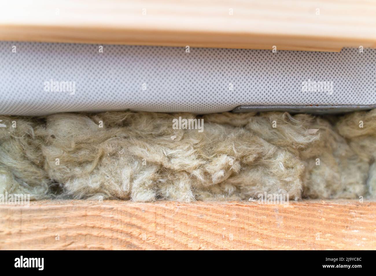Roof insulation with mineral wool, close-up. Mineral wool between the ...