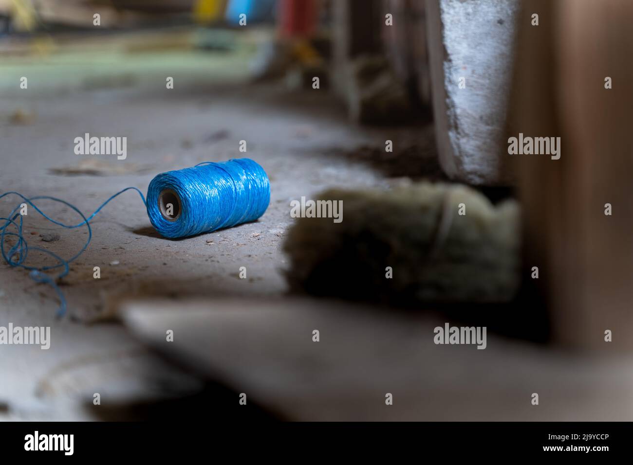 Blue polypropylene construction thread lies on the floor at a ...
