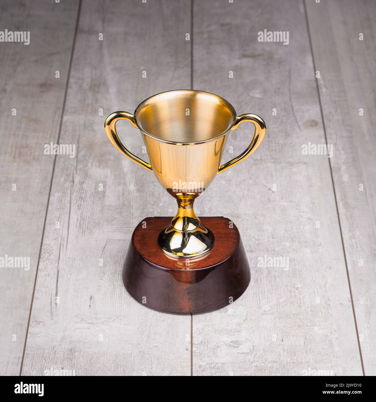 Golden trophy on wood background Stock Photo - Alamy