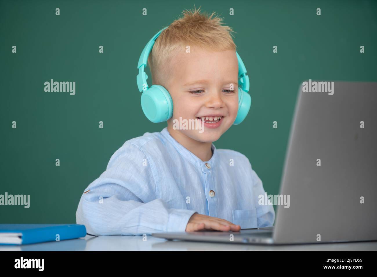 Cute little child using laptop computer, kid boy studying through ...