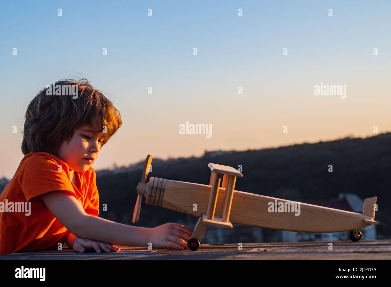 Dreams of flight. Child playing with toy plane against the sky. Dreams ...