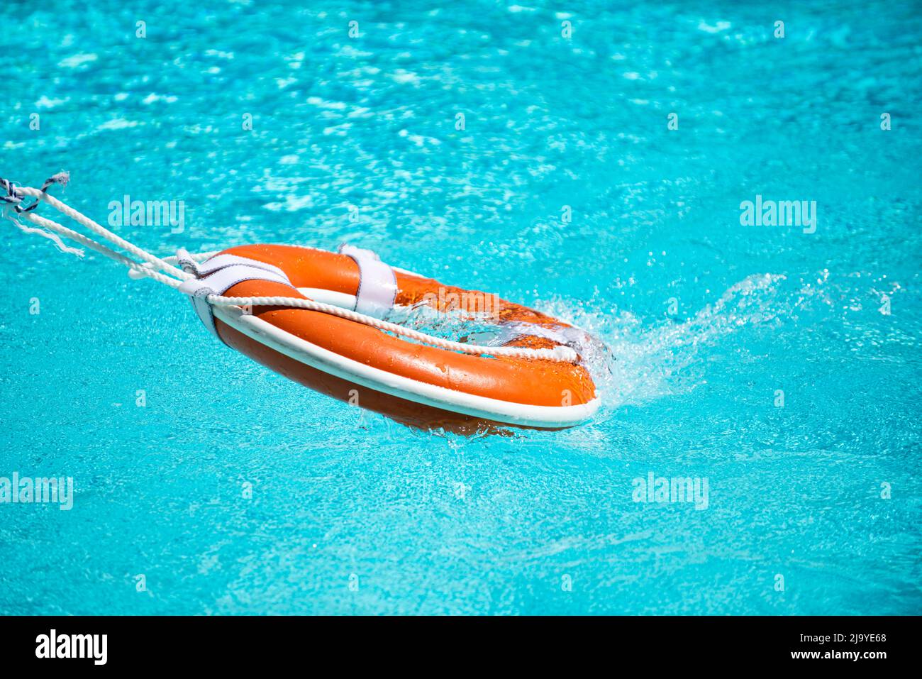 Lifebuoy pool ring float on blue water Stock Photo - Alamy