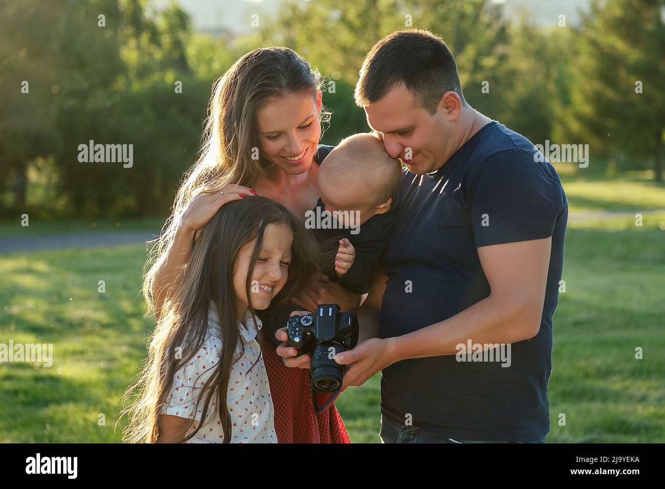 happy family is resting in the park in summer . beautiful mother ...