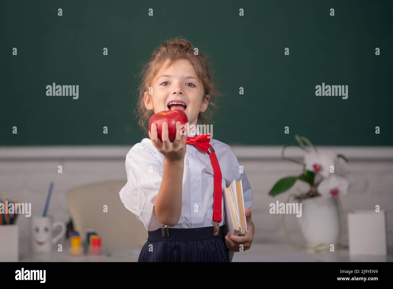 Portrait of funny pupil girl of primary school study. First day at ...