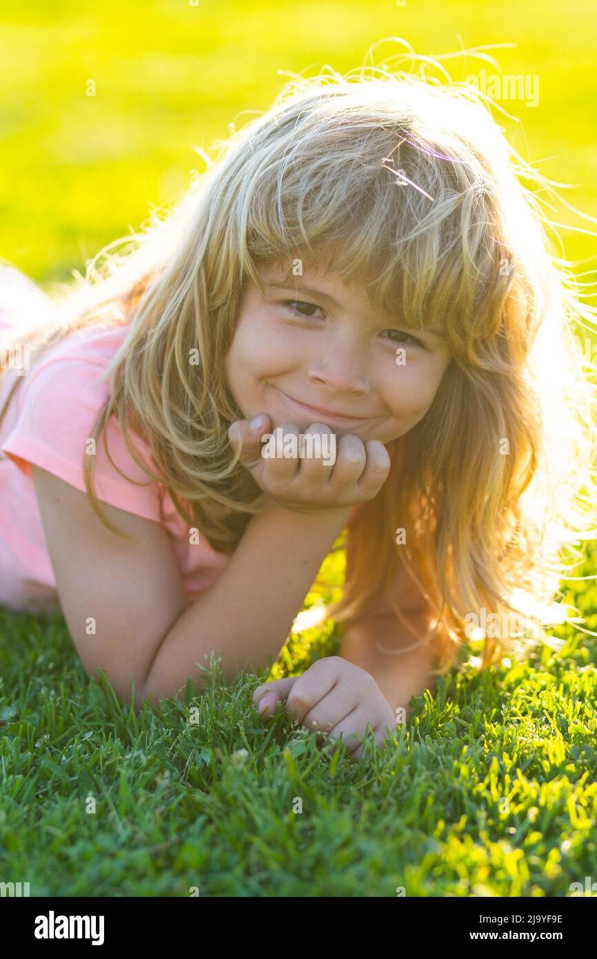 Summer child face. Smiling child boy with grass background. Child in ...