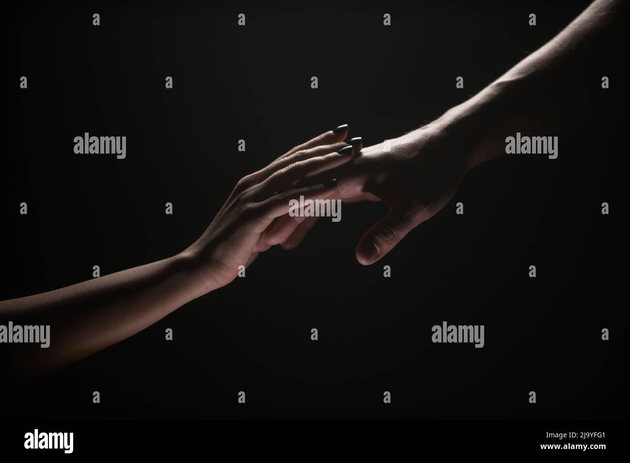 Two hands at the moment of farewell. The holding hands of relations ...