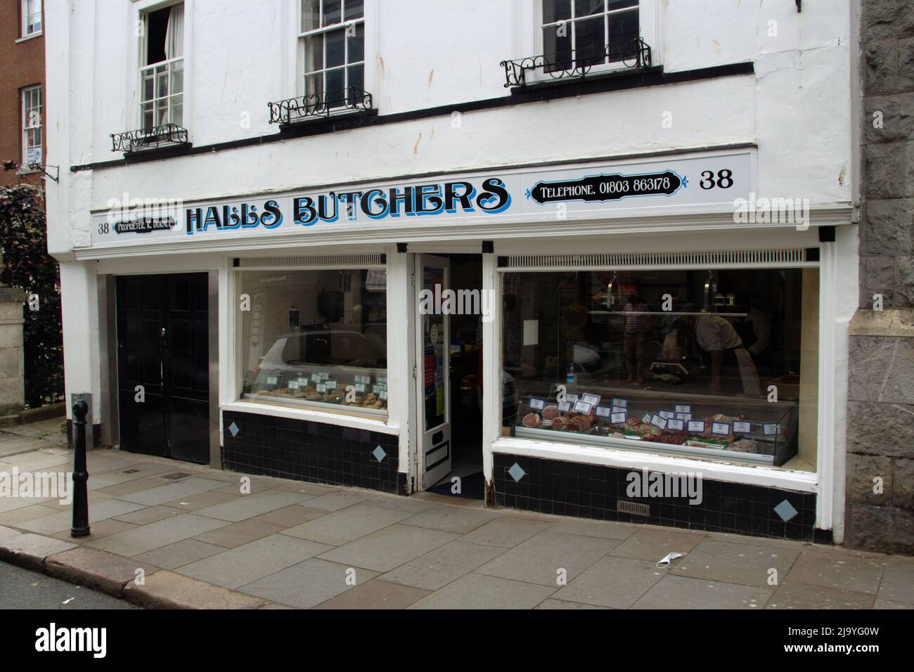 TOTNES, UK - JUNE 26, 2021 Halls Butchers on Fore Street on a cloudy ...