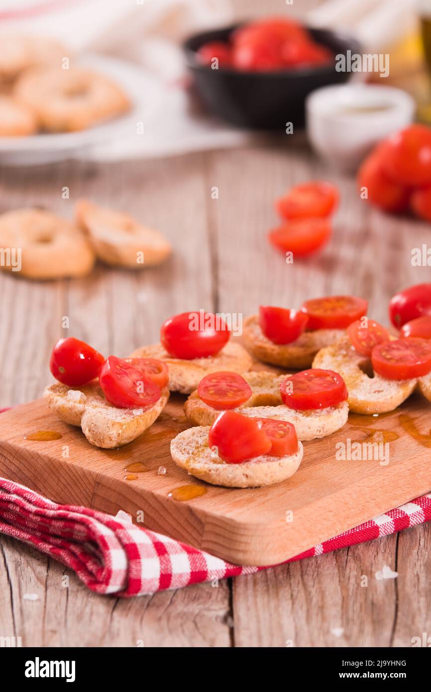 Friselle with cherry tomatoes and salt Stock Photo - Alamy