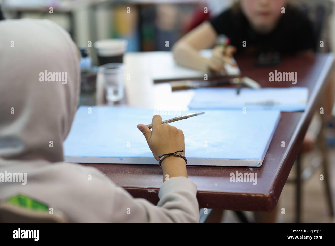 Child draws with brush and draws picture closeup Stock Photo - Alamy