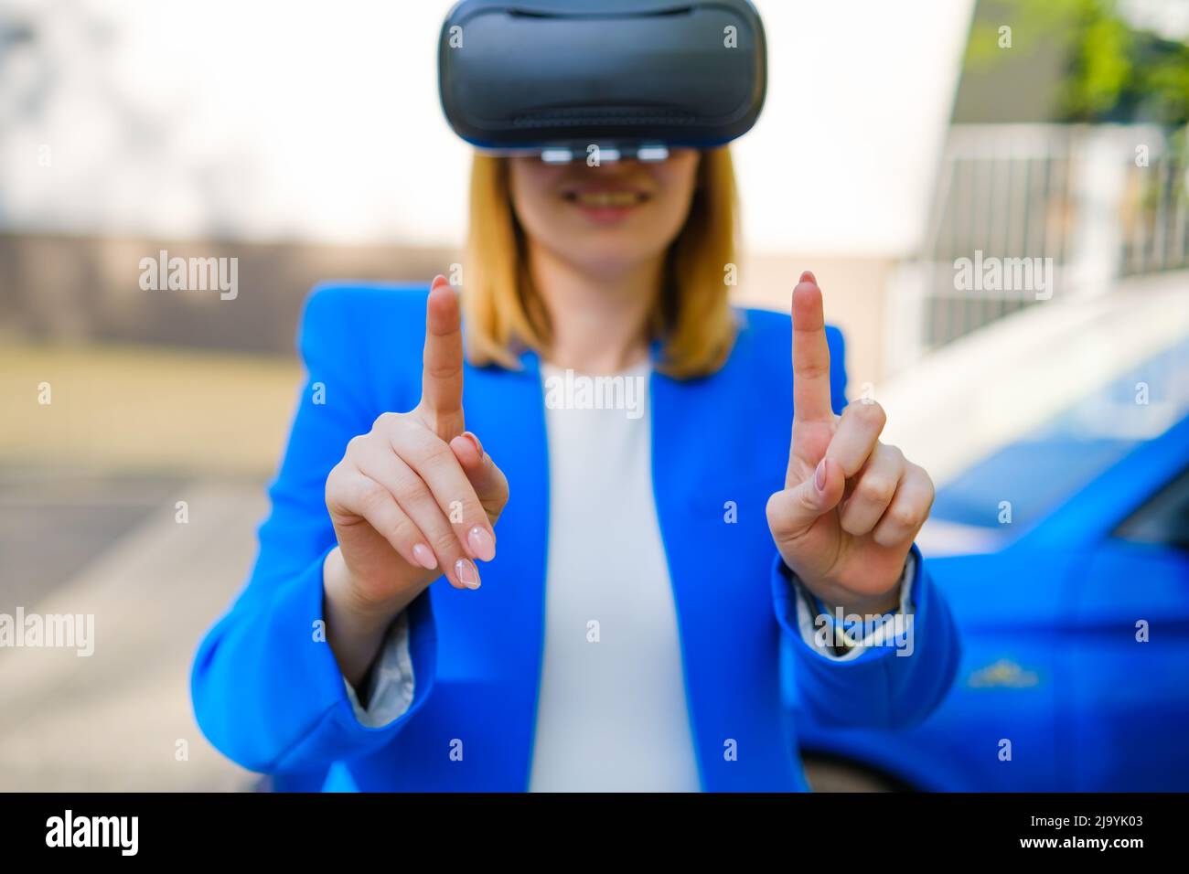 Business woman using VR goggles, moving her head touching the ...