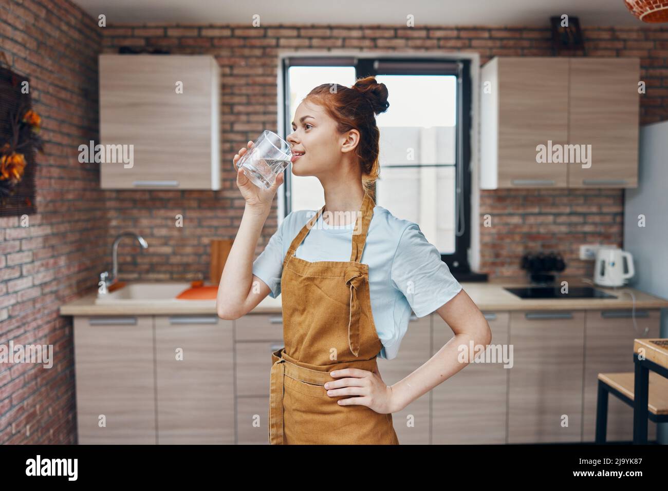 a housewife drinking water kitchen apartment kitchen utensils interior modern style Stock Photo ...