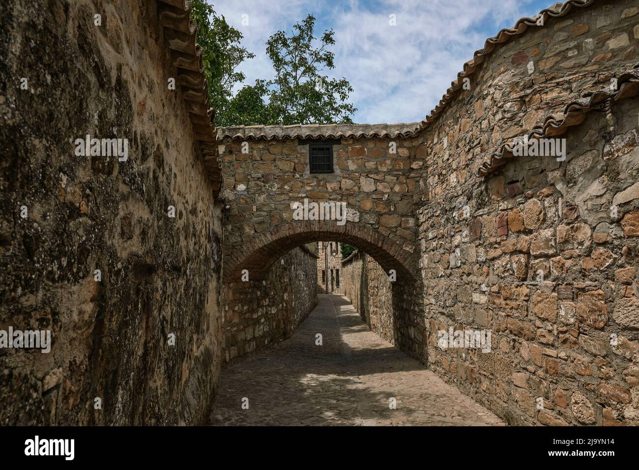 medieval stone walkway with wall and archway Stock Photo - Alamy