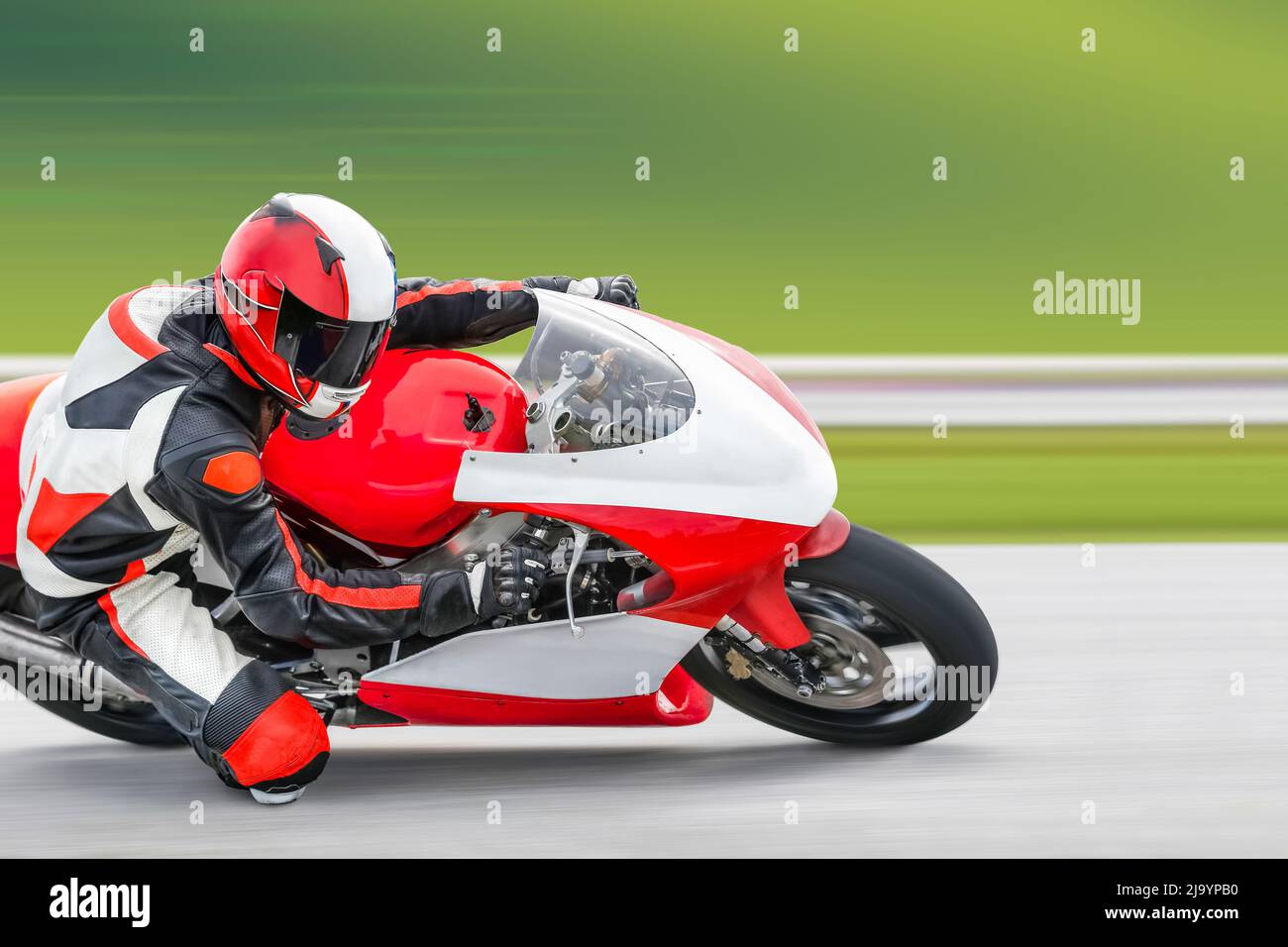 Motorcycle practice leaning into a fast corner on track Stock Photo - Alamy