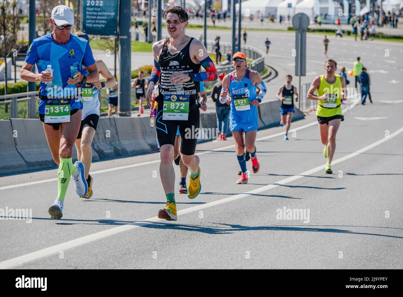 Kazan, Russia - May 17, 2022: group male runners run down street during ...