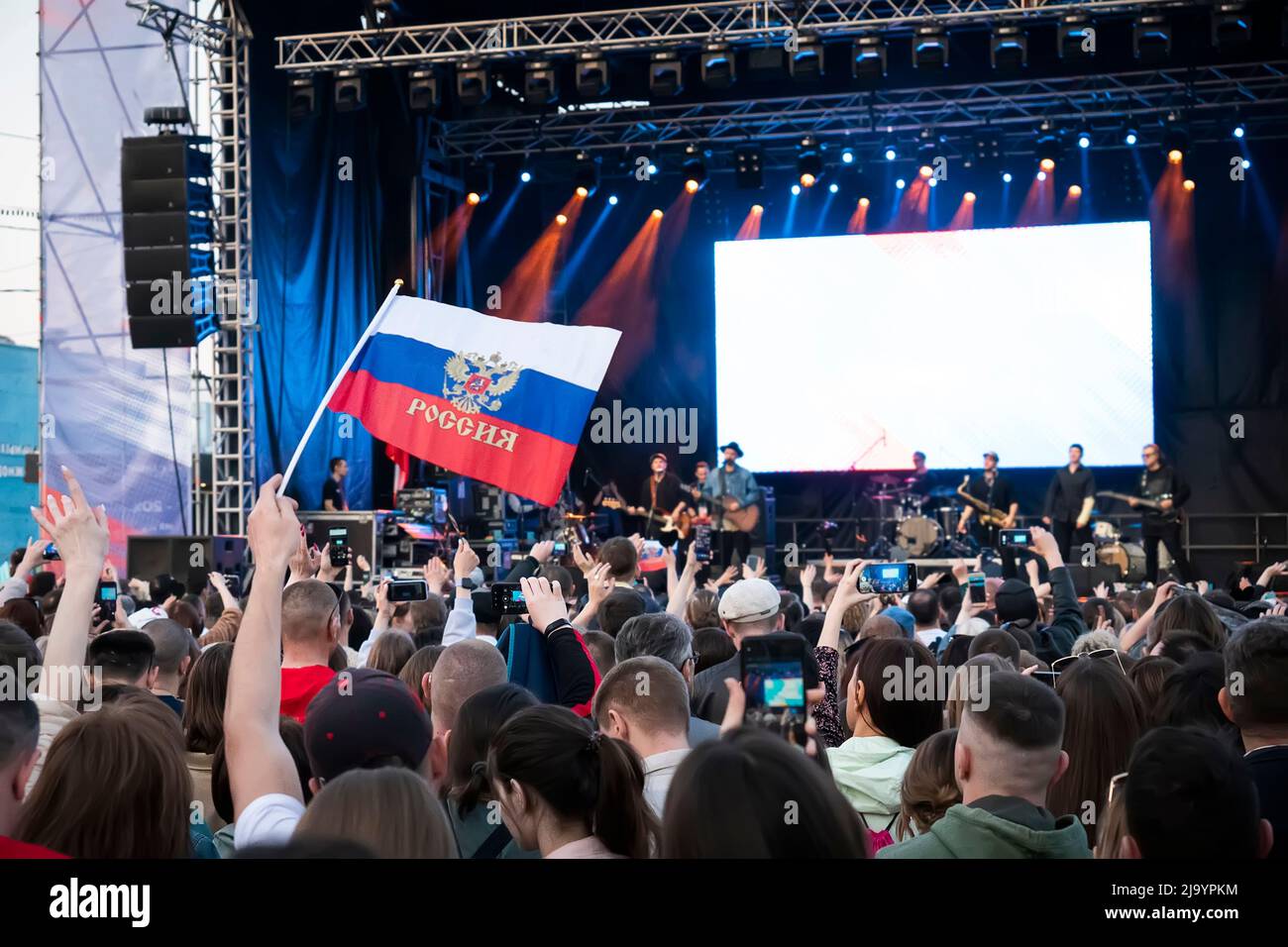 The Russian flag in a crowd of people. The audience at a street concert ...