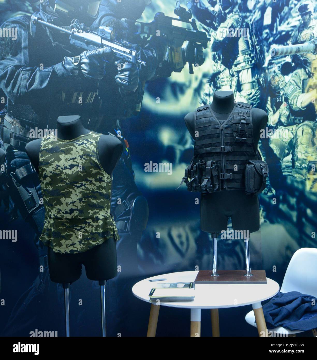 Military bandolier, uniform and bulletproof on stand. Arms and Safety ...