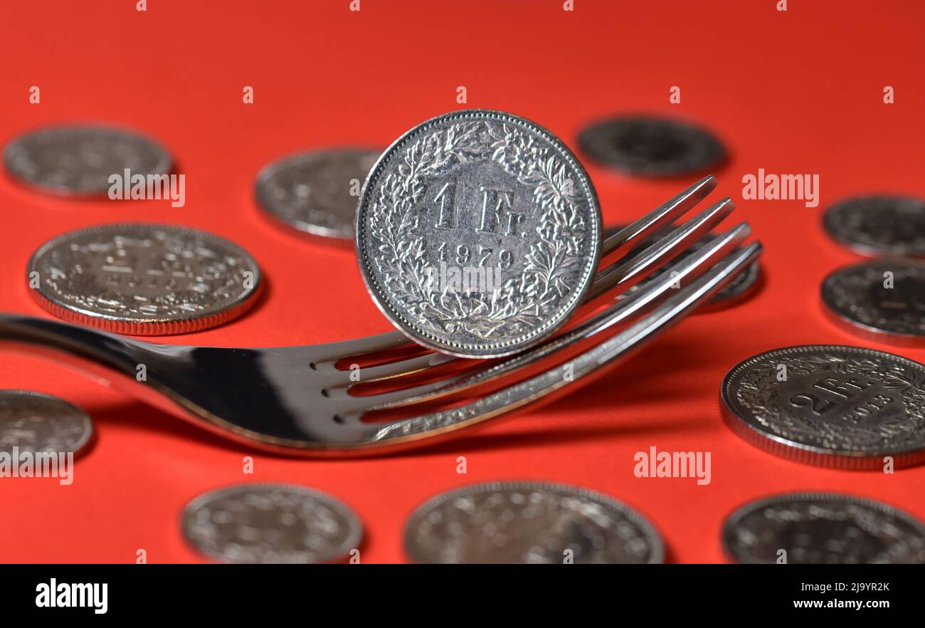one swiss franc money coin with dinner fork Stock Photo - Alamy