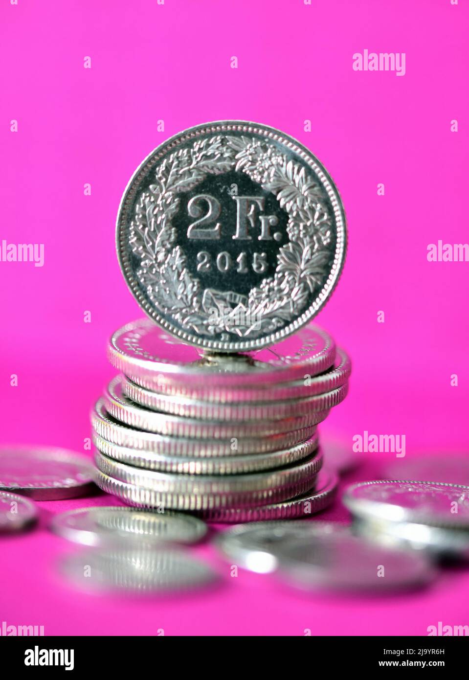 swiss two franc coin on pink background Stock Photo - Alamy
