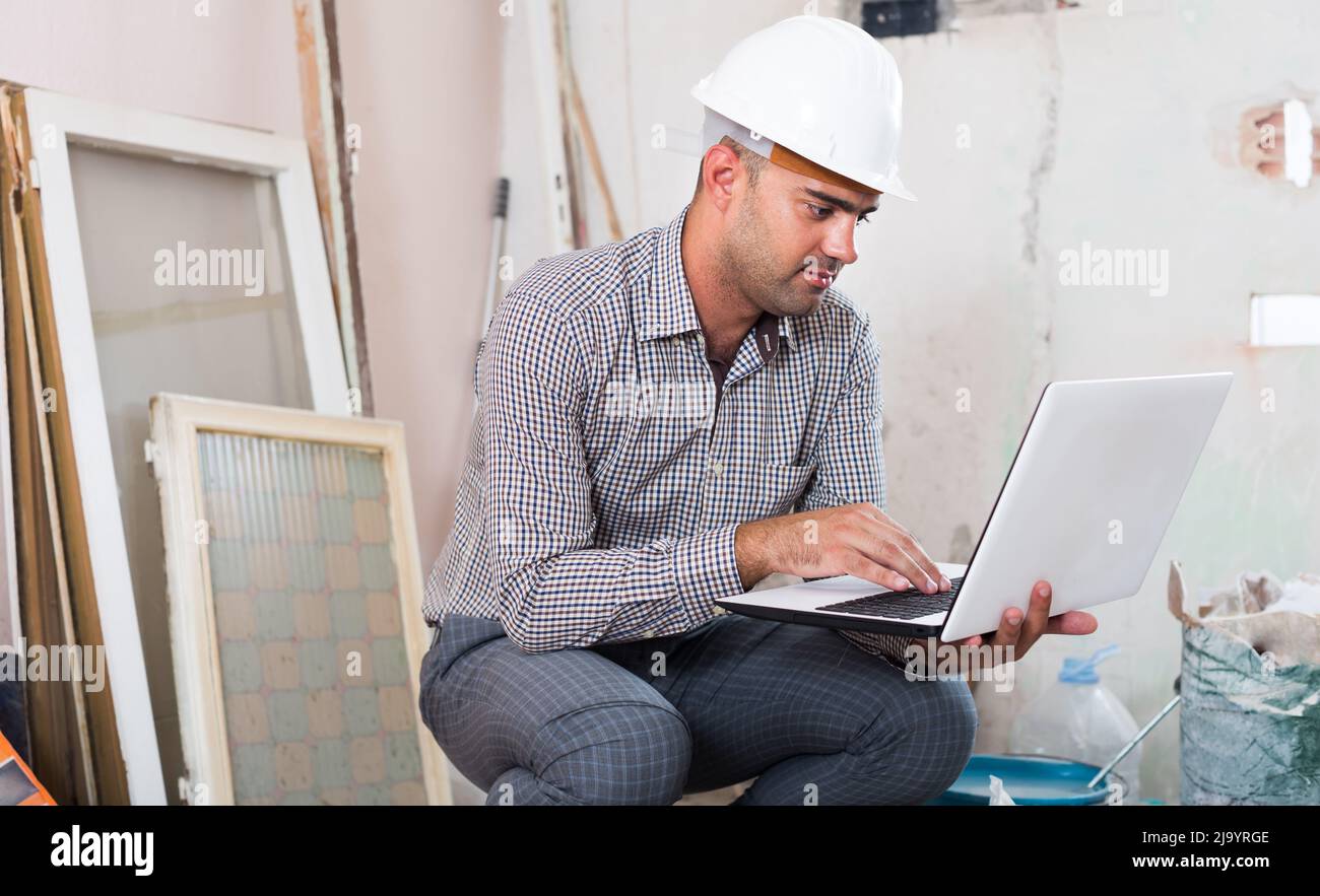 constructor working at the notebook Stock Photo - Alamy